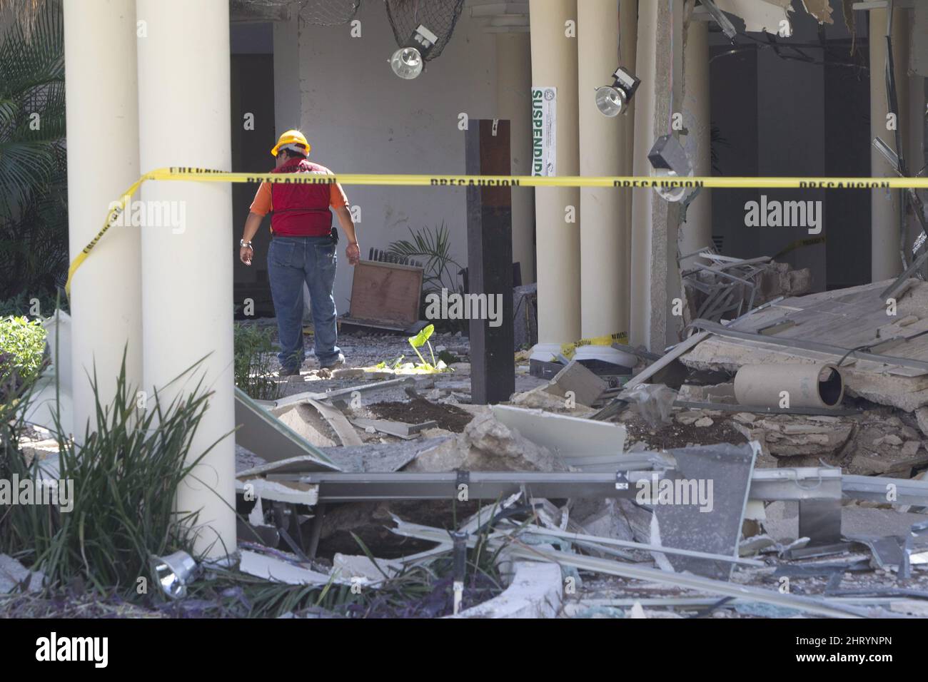 Workers survey the damage caused by an explosion at the Grand Princess ...