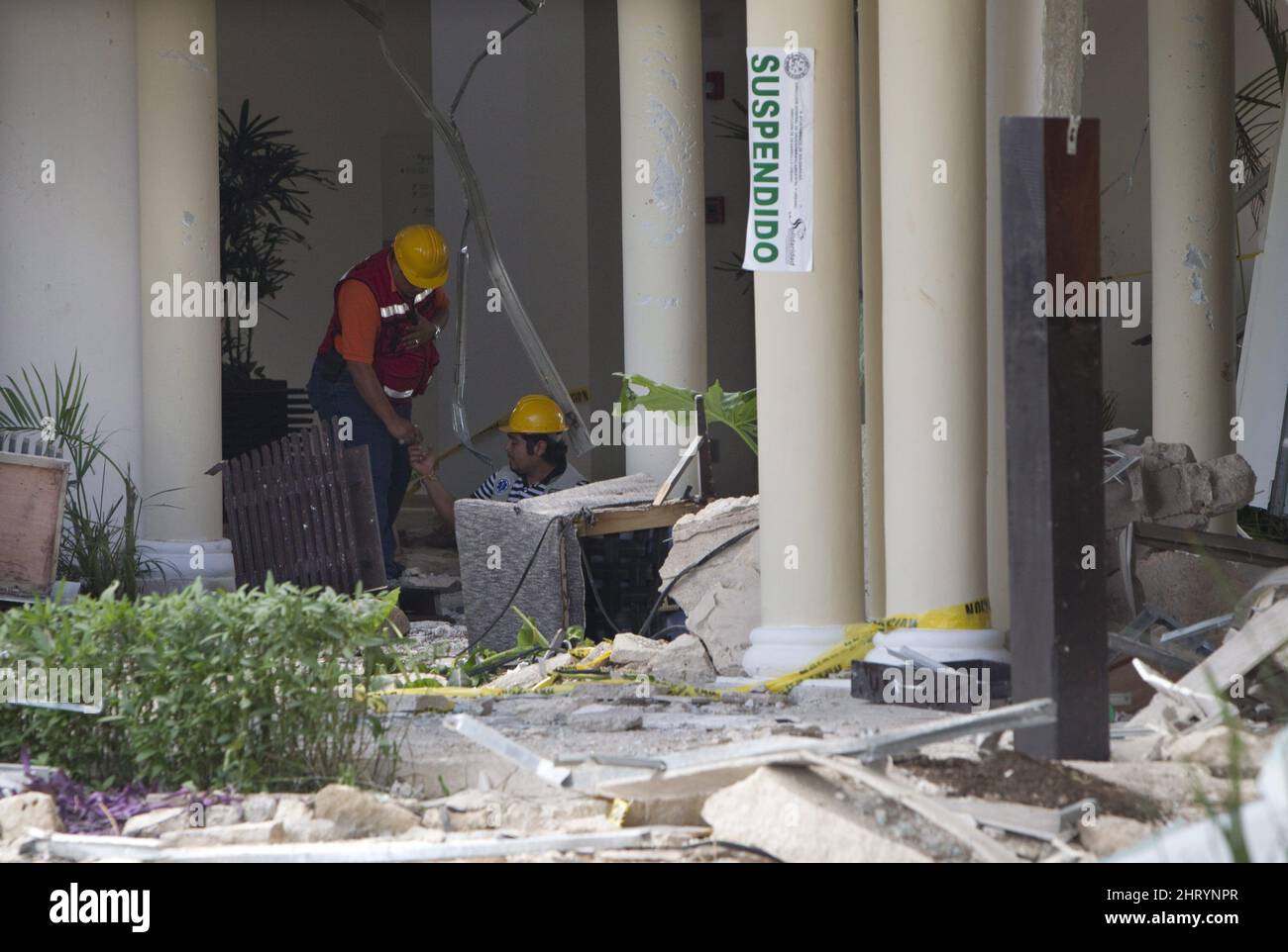 Workers survey the damage caused by an explosion at the Grand Princess ...