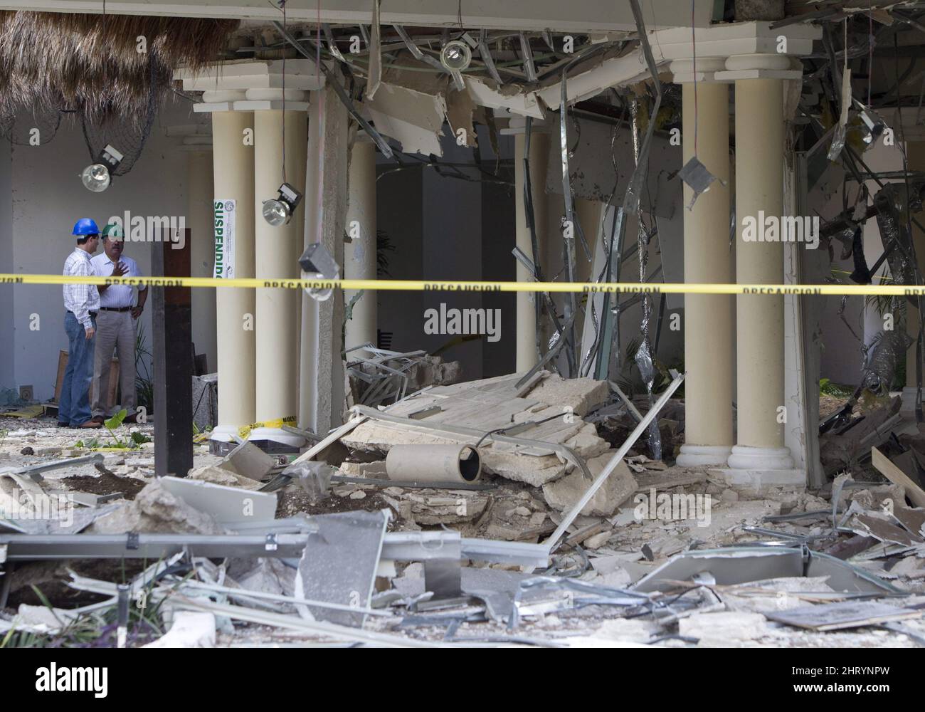 Workers survey the damage caused by an explosion at the Grand Princess ...