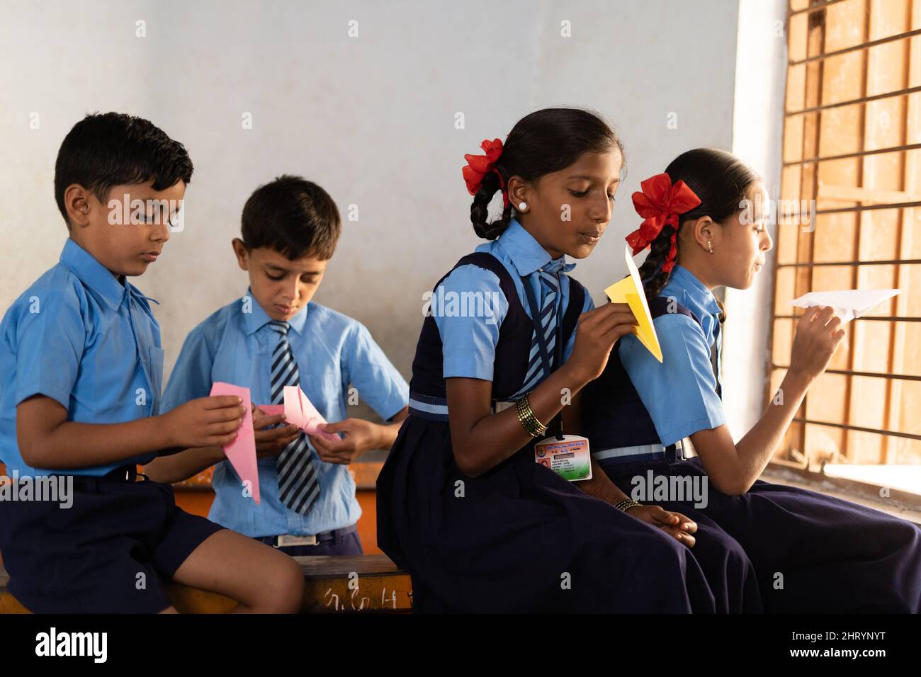 children at school playing by throwing paper rocket out of window from ...