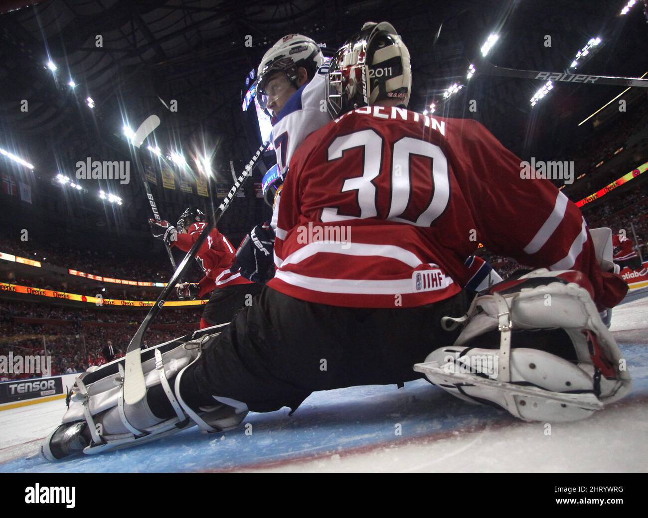 Team Canada goaltender Mark Visentin gets hit by Team USA forward Ryan ...