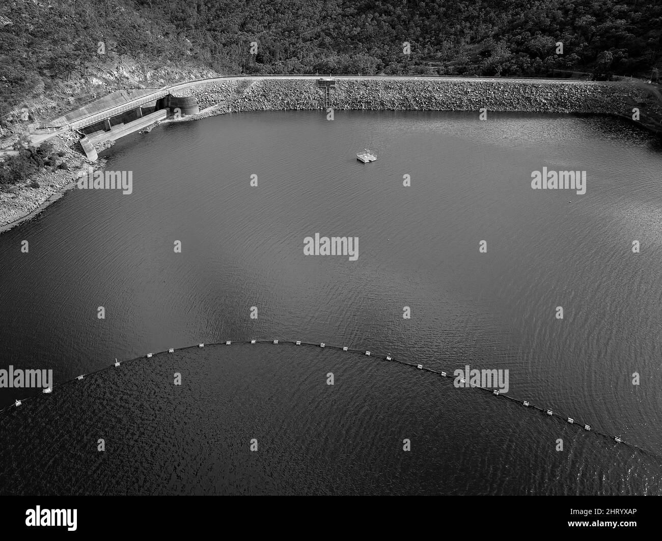 Eungella Dam wall built between mountains with overflow channel and ...