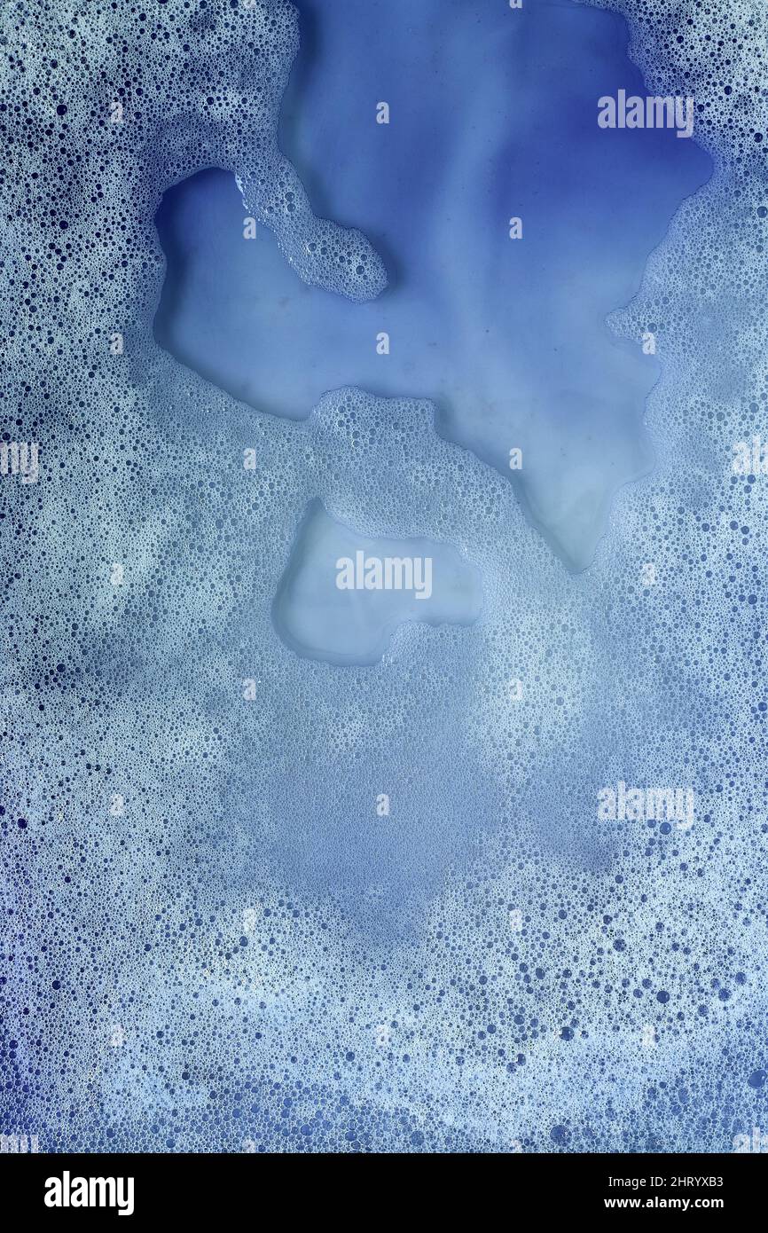 Soap and shampoo foam on purple and blue background. Seamless detergent ...