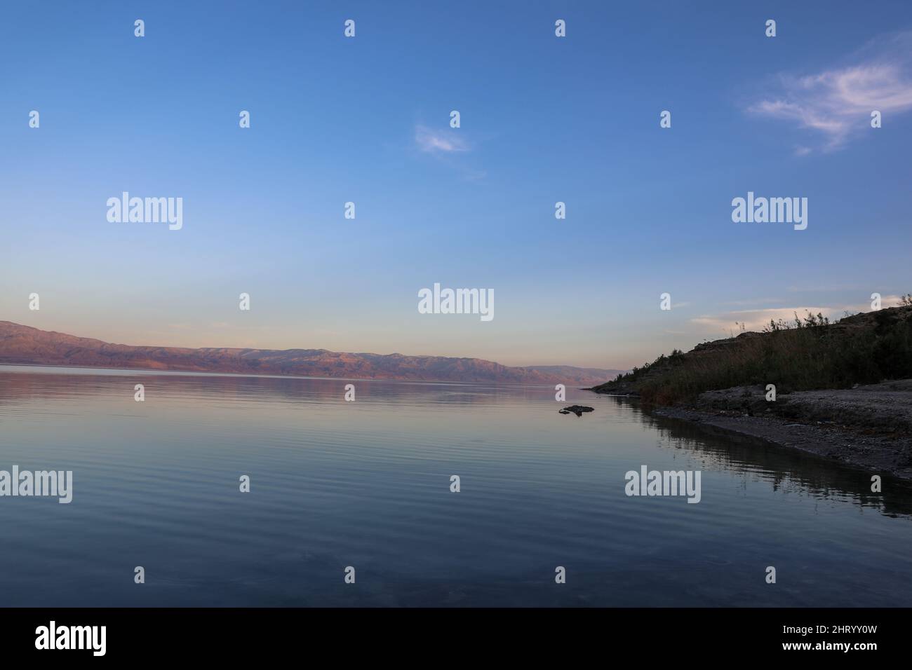 View of the vibrant sunset looking towards the horizon at the Dead Sea ...
