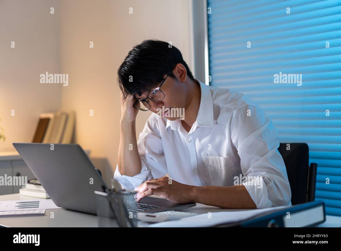 Overwork Concept The male officer resting his forehead on his right ...