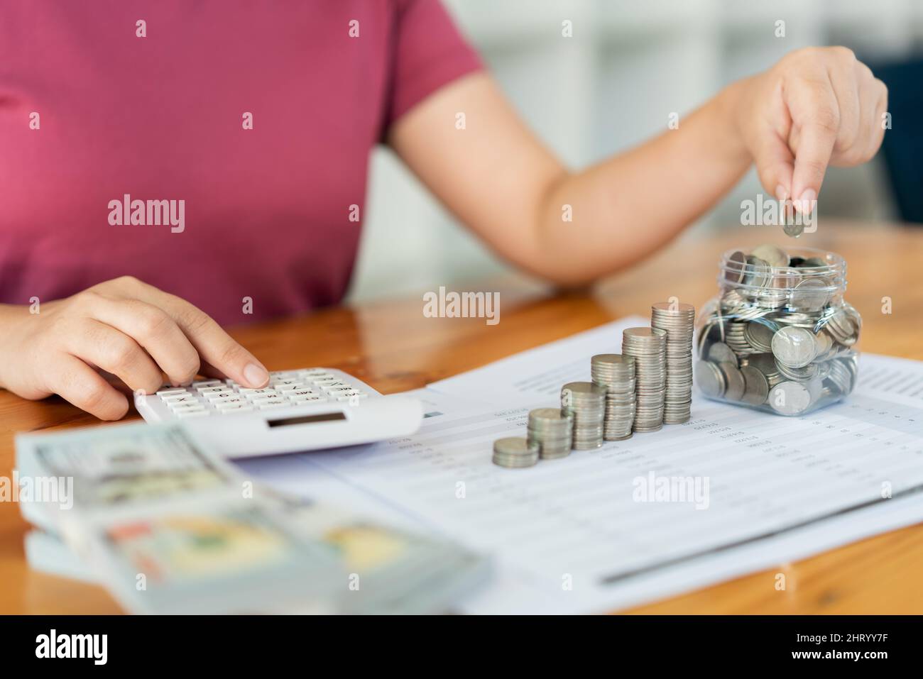 Saving concept the woman piling her coins and counting the money by ...