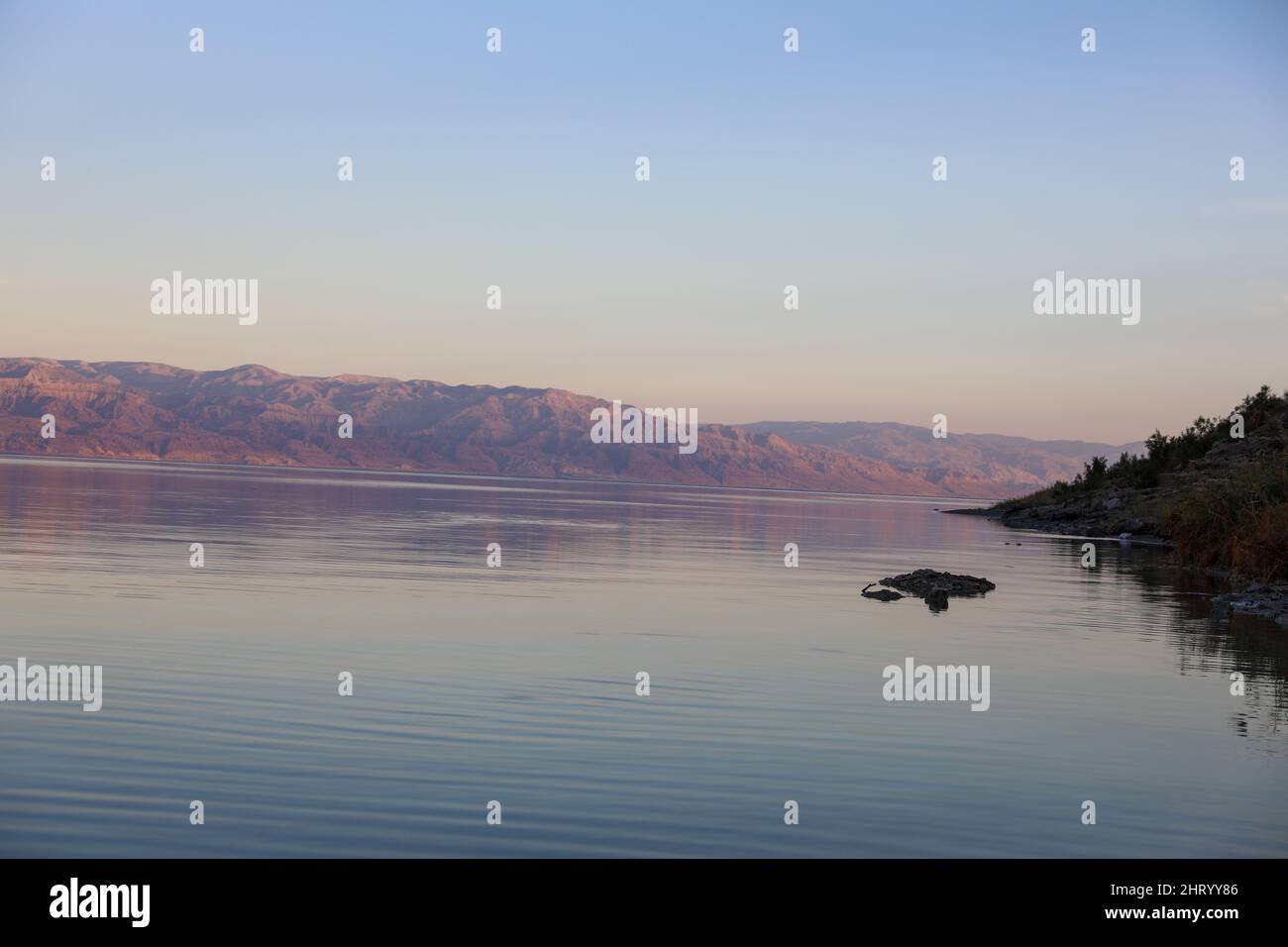 View of the vibrant sunset looking towards the horizon at the Dead Sea ...