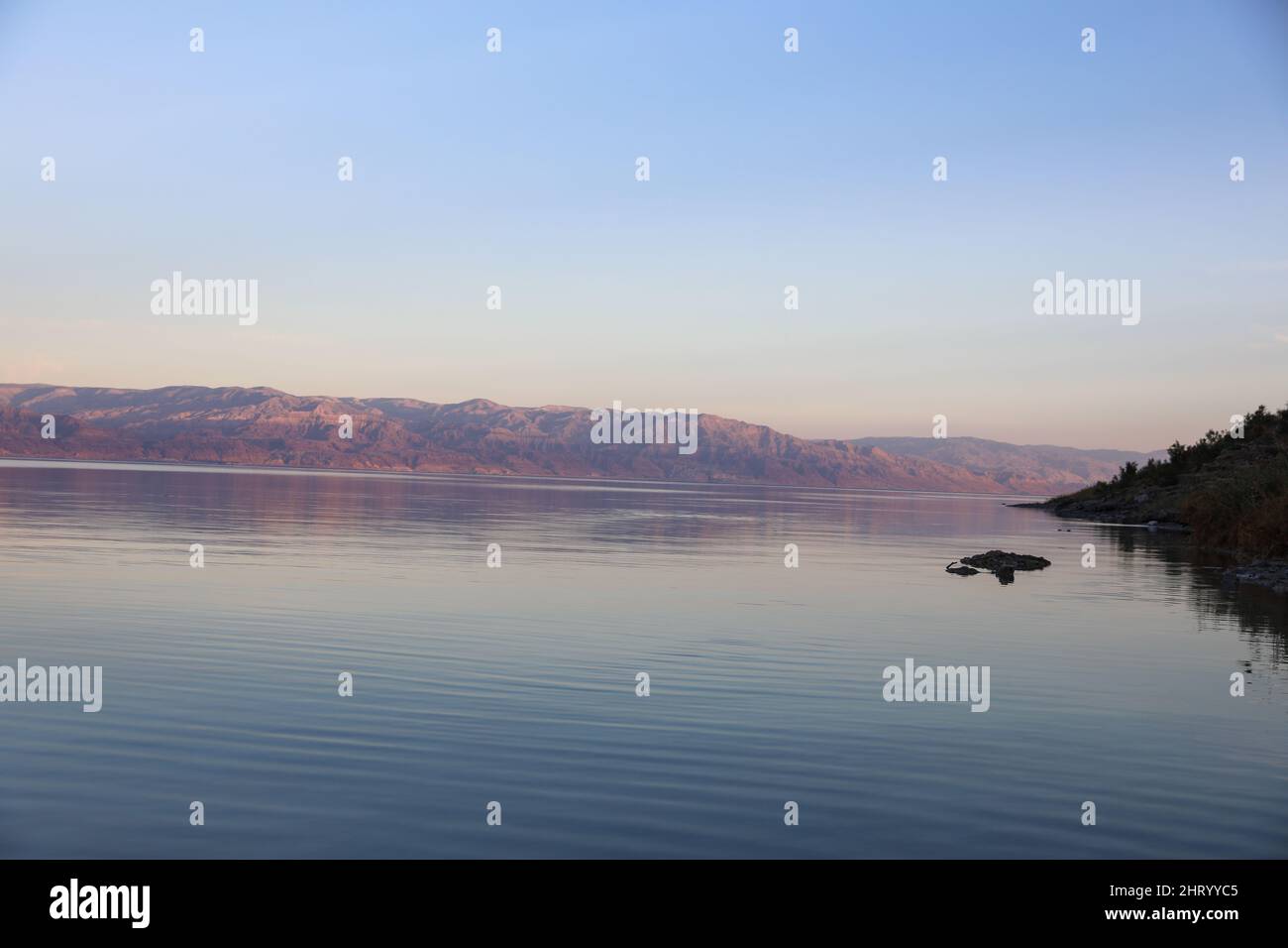 View of the vibrant sunset looking towards the horizon at the Dead Sea ...