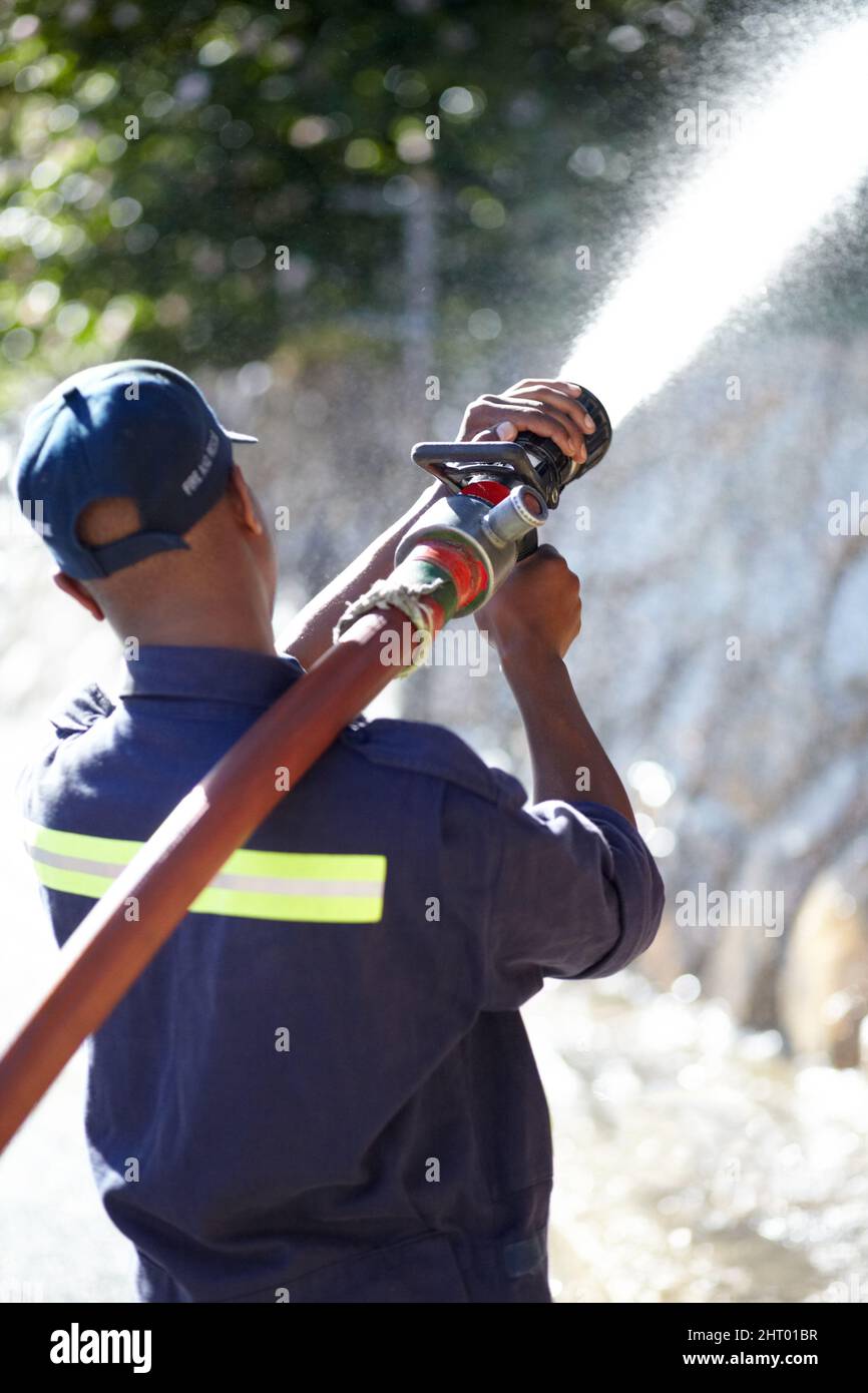 Fireman holding water hose hi-res stock photography and images - Alamy