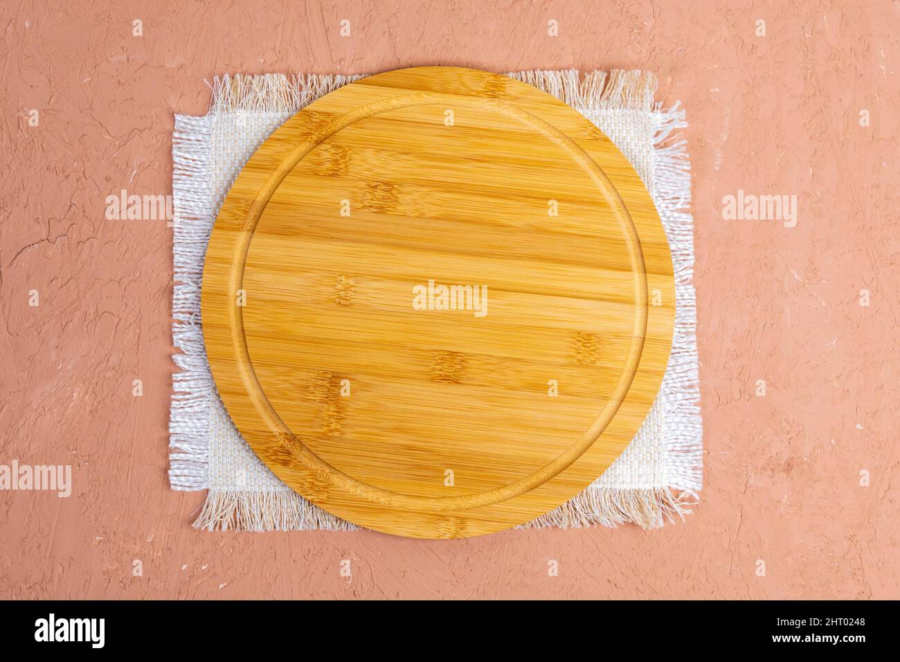 Empty wooden plate on wood table. Wood plate for food. Flat lay. Copy ...
