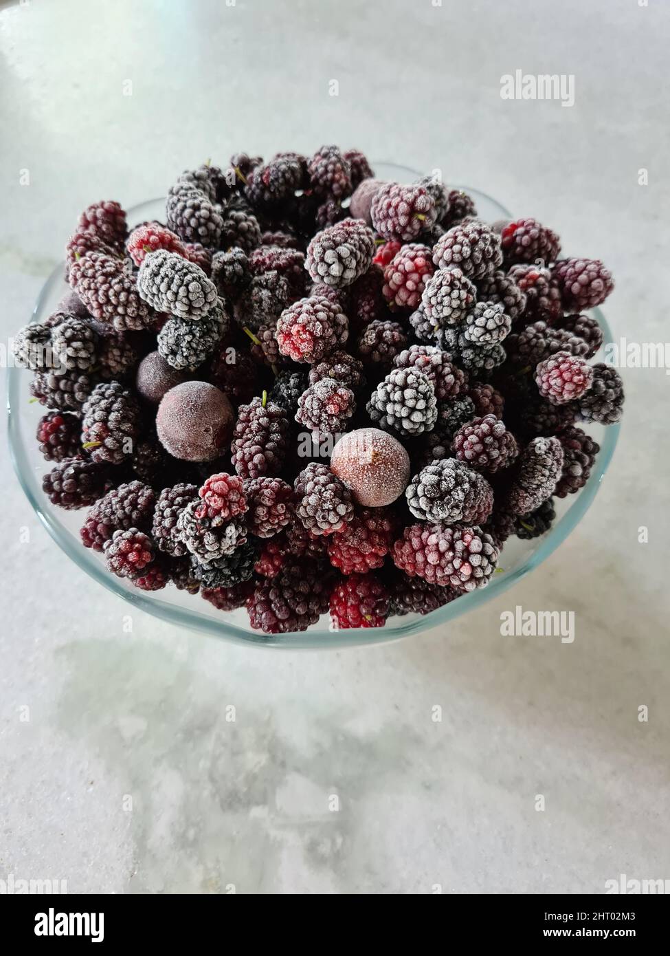 Bowl of frozen raspberries in the kitchen Stock Photo - Alamy
