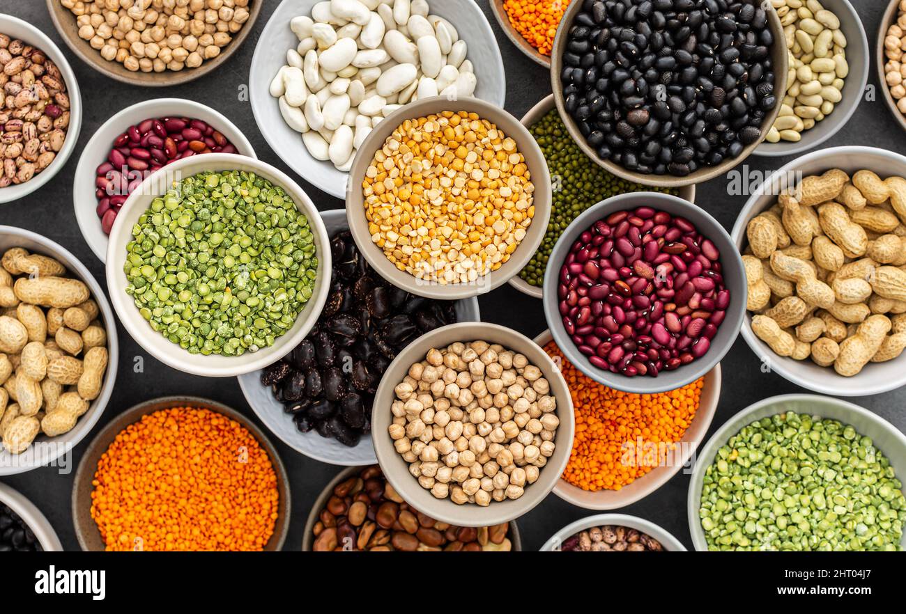 Different types of legumes in bowls, green with yellow peas and mung ...