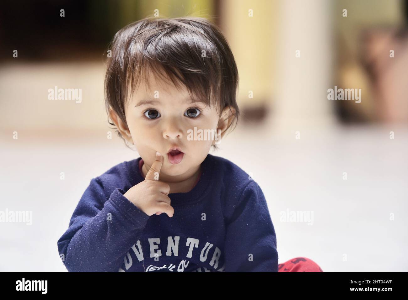 Close-up shot of a cute South Asian baby boy sitting and looking with a curious face Stock Photo ...