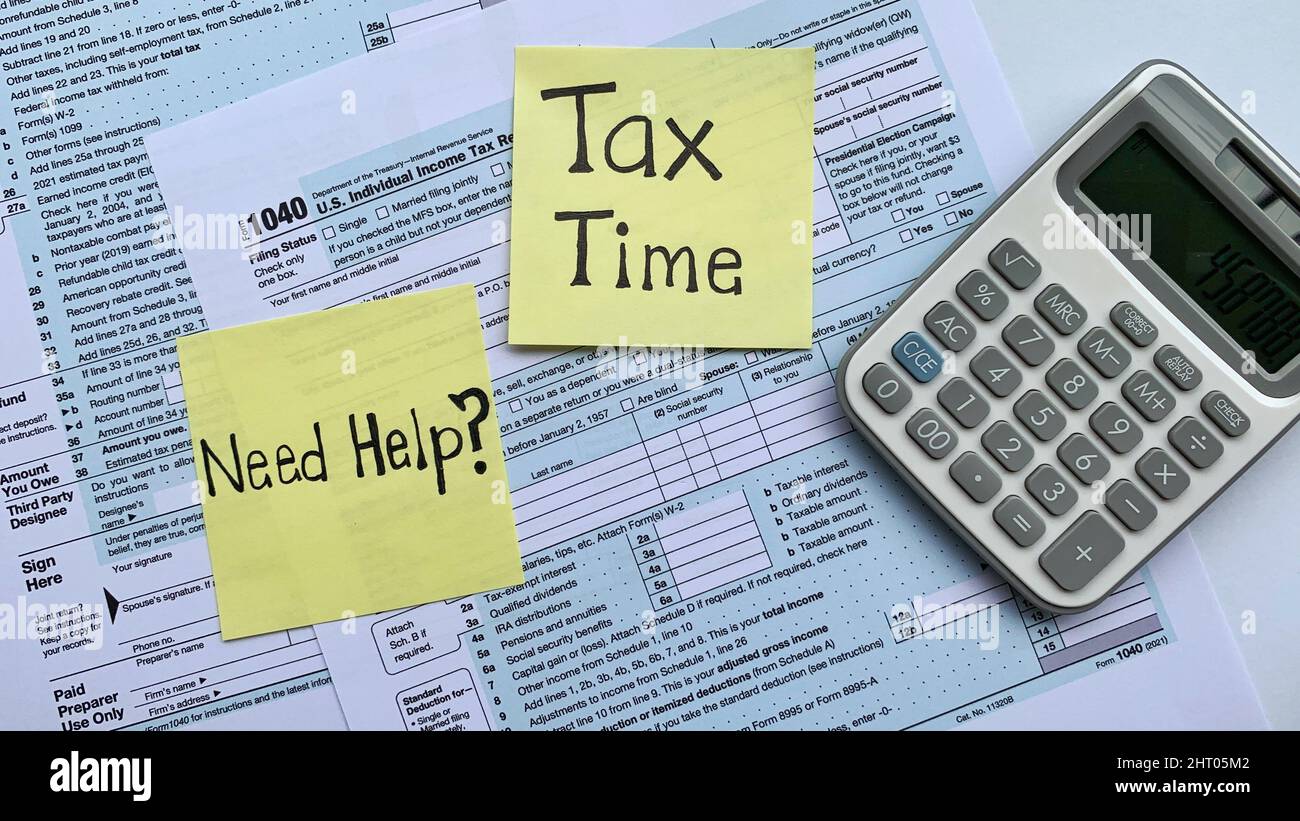 Top view of text on yellow notepad - Need help, tax time. With tax form ...