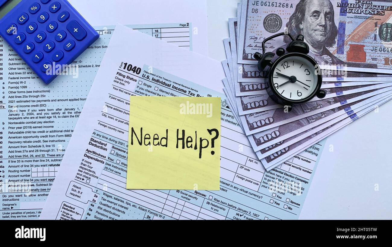 Top view of text on yellow notepad - Need help. With tax form, bank ...