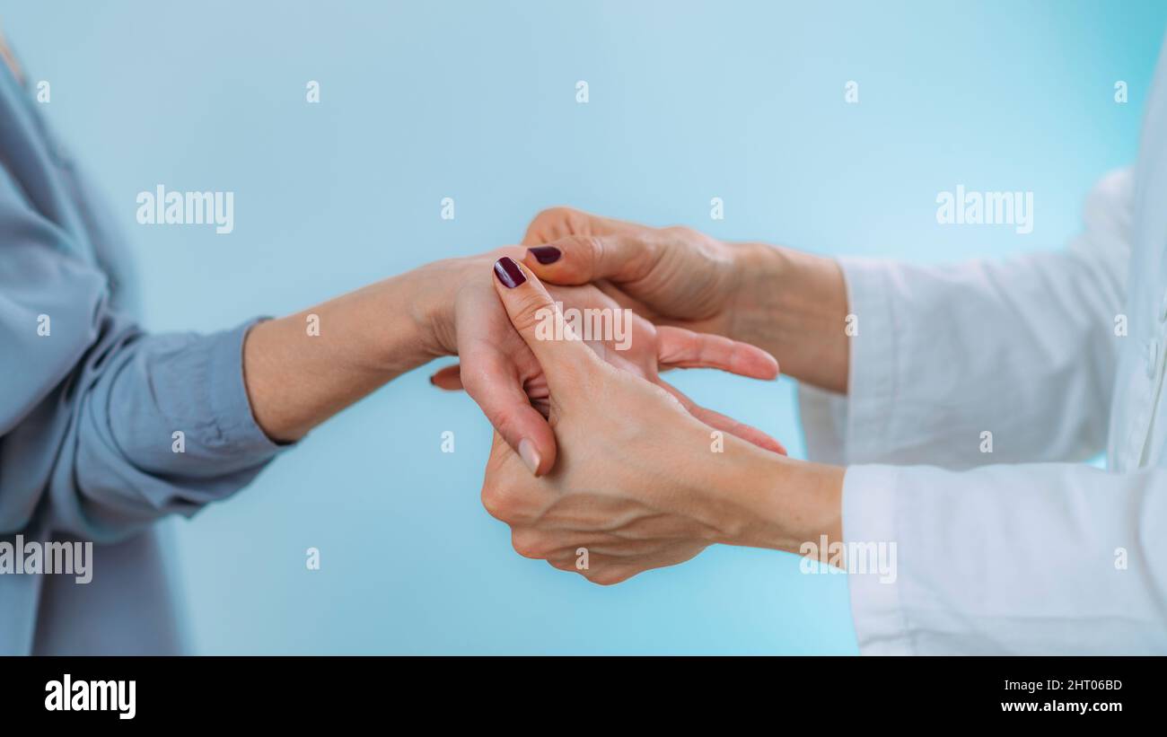 Doctor examining hand of senior patient with pain in wrist Stock Photo ...