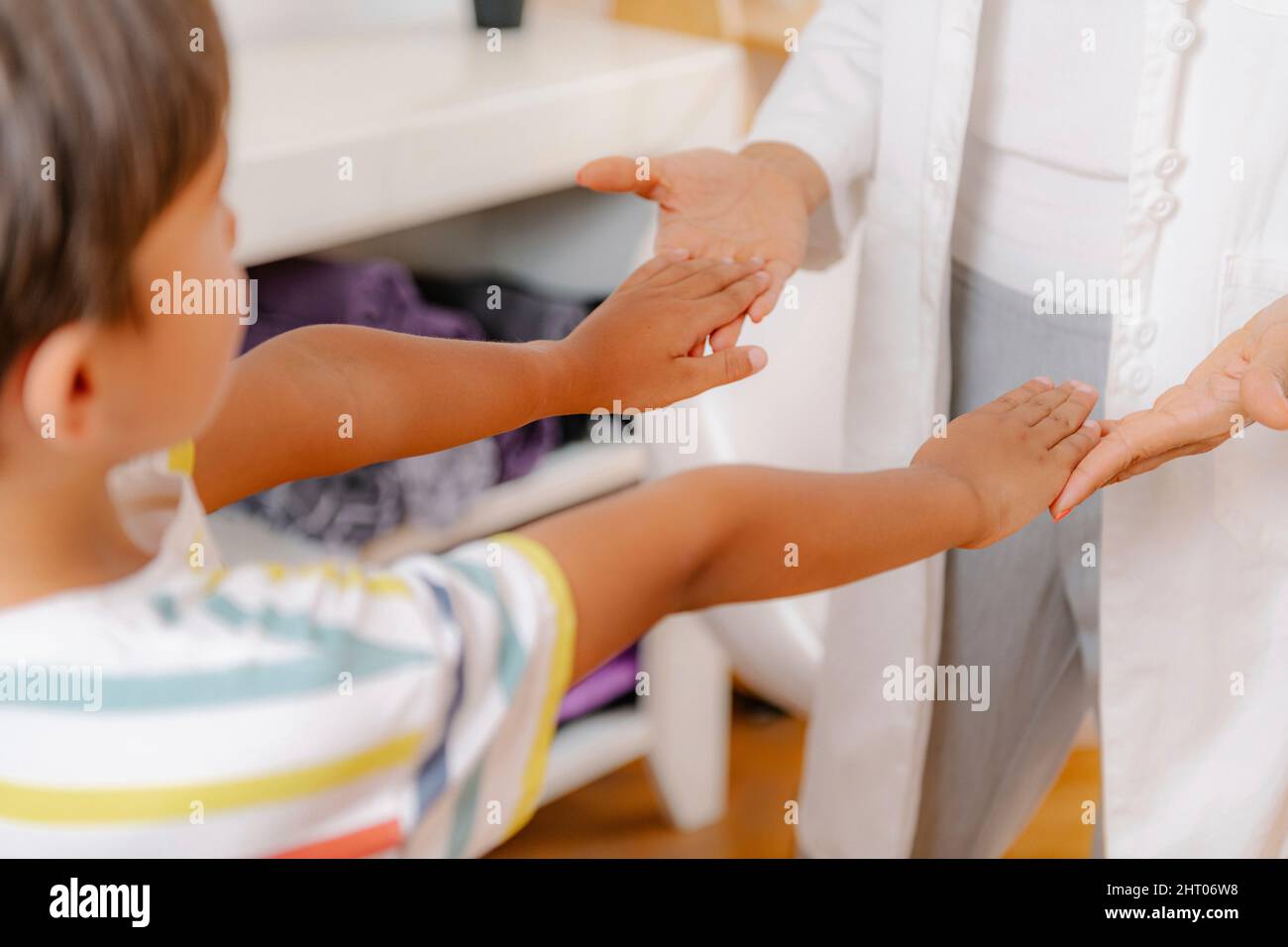 Boy holding arms raised during a physical medical exam Stock Photo - Alamy