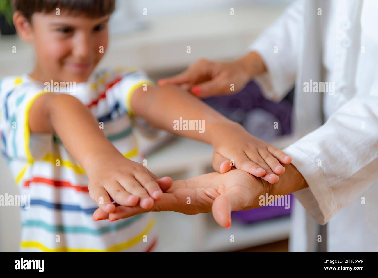 Boy holding arms raised during a physical medical exam Stock Photo - Alamy