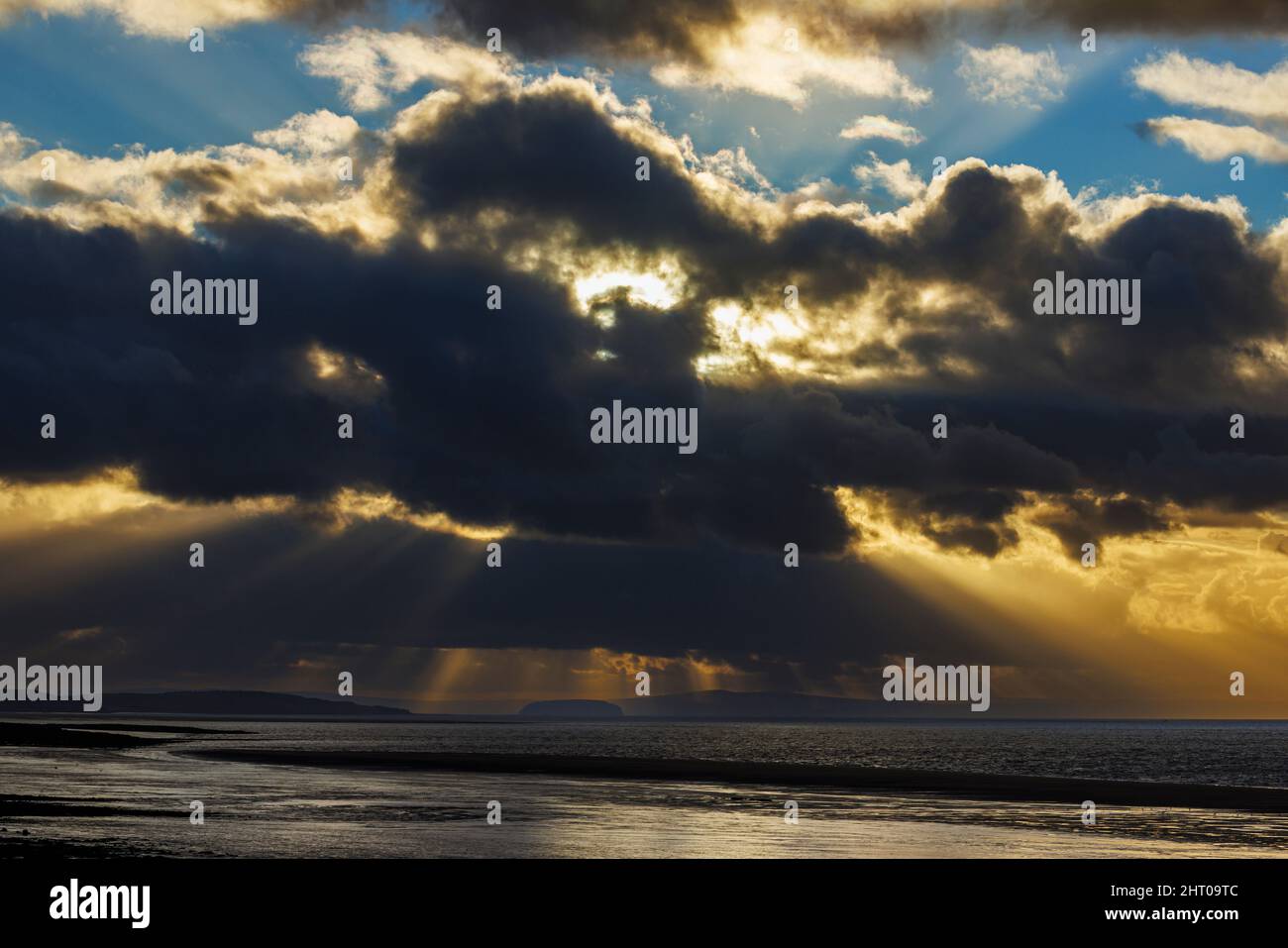 Crepuscular rays breaking through the cloud cover Stock Photo - Alamy