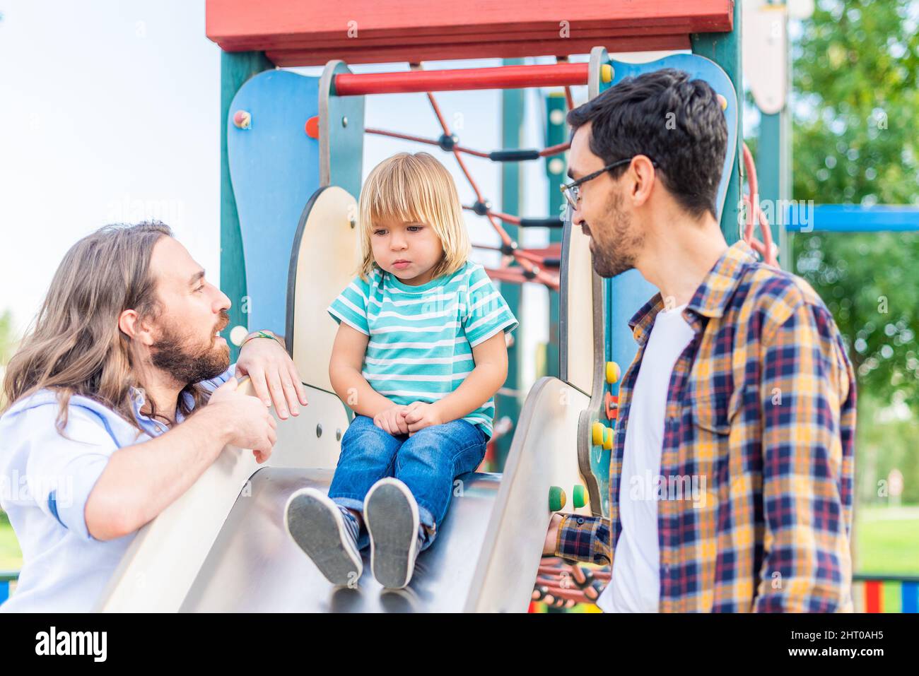 boy on top of slide looking down with a fear Stock Photo - Alamy