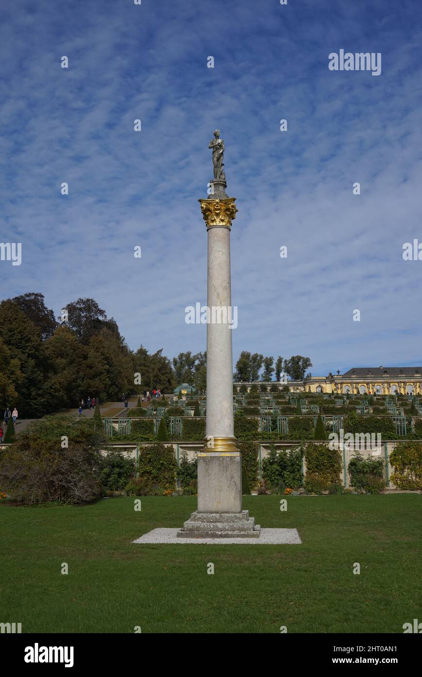 Column with a sculpture on top in a park Stock Photo - Alamy