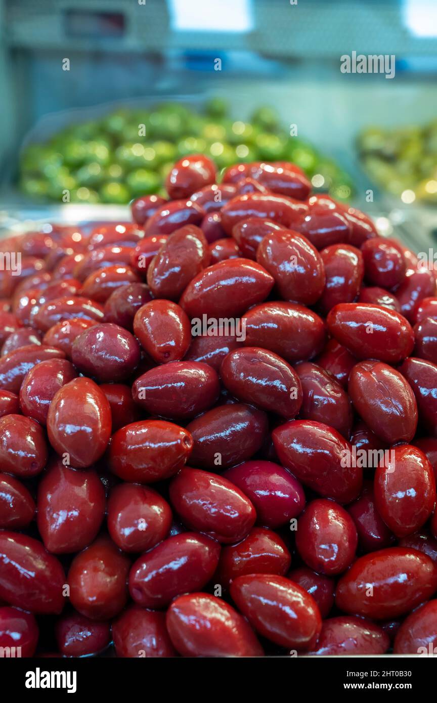 Red olives close up on market, healthy vegetarian food background Stock ...