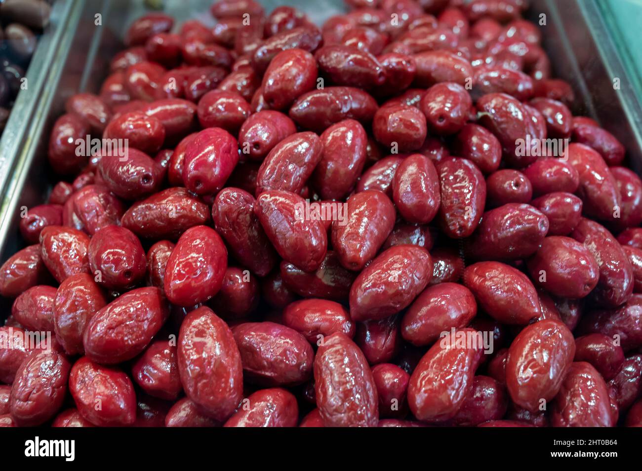Red olives close up on market, healthy vegetarian food background Stock ...