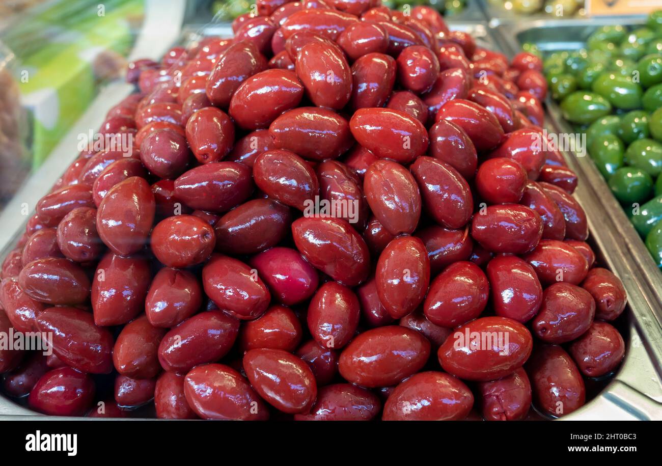 Red olives close up on market, healthy vegetarian food background Stock ...