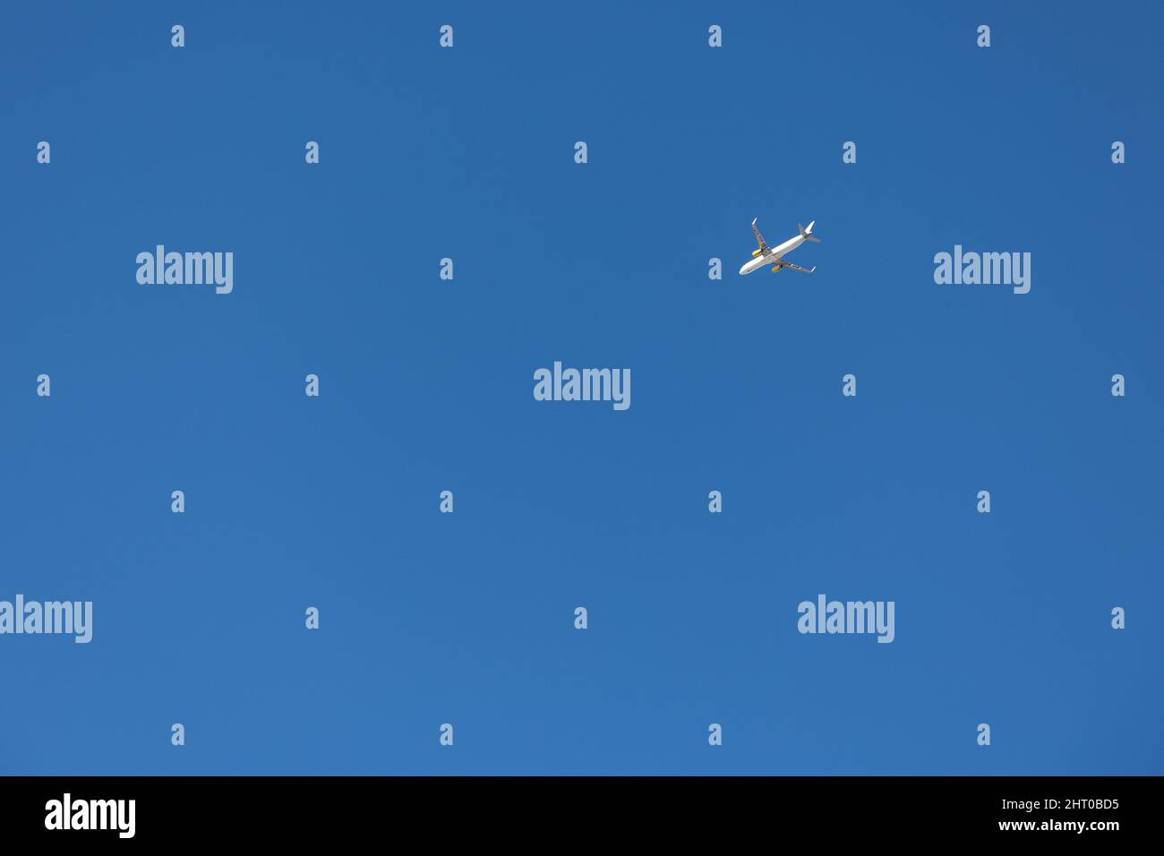 View of a big plane flying in the blue sky Stock Photo - Alamy