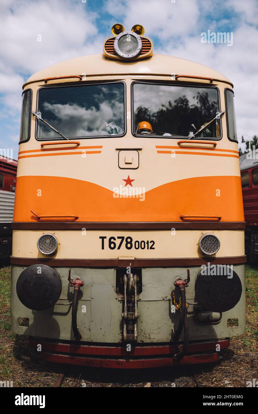 Vertical shot of orange diesel locomotive engine T678 resting at a freight yard Stock Photo - Alamy