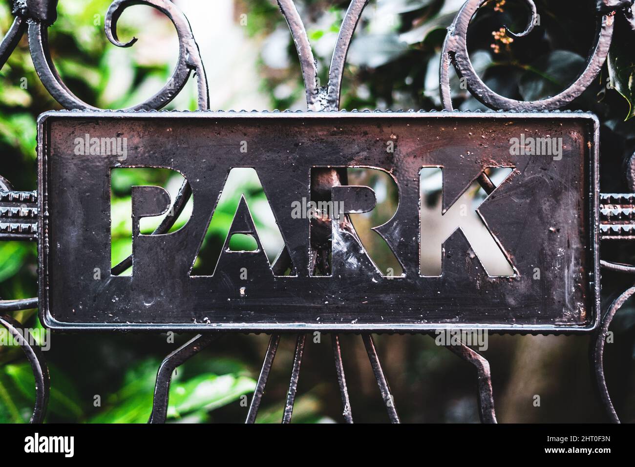 Close-up shot of a park sign on a metal gate Stock Photo - Alamy