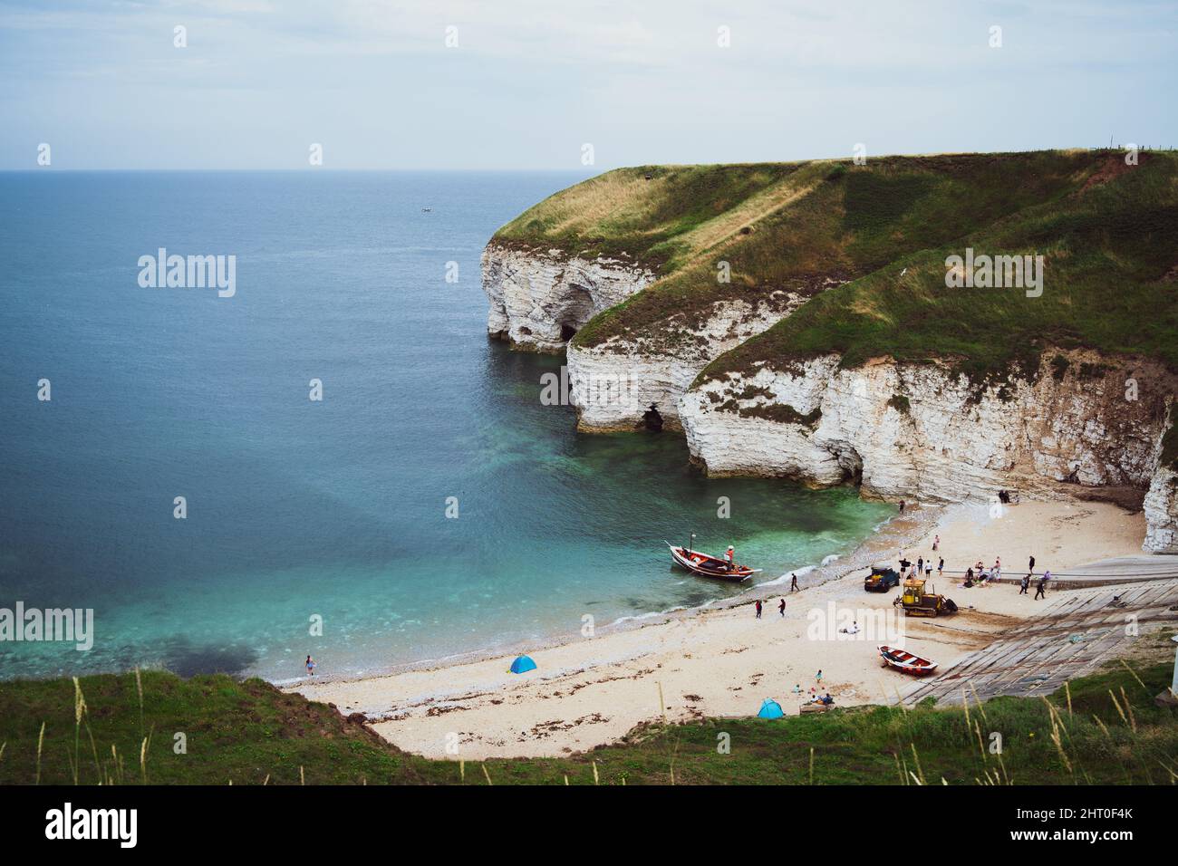 Cliffs in Flamborough people at the beach throwing stones to the sea ...