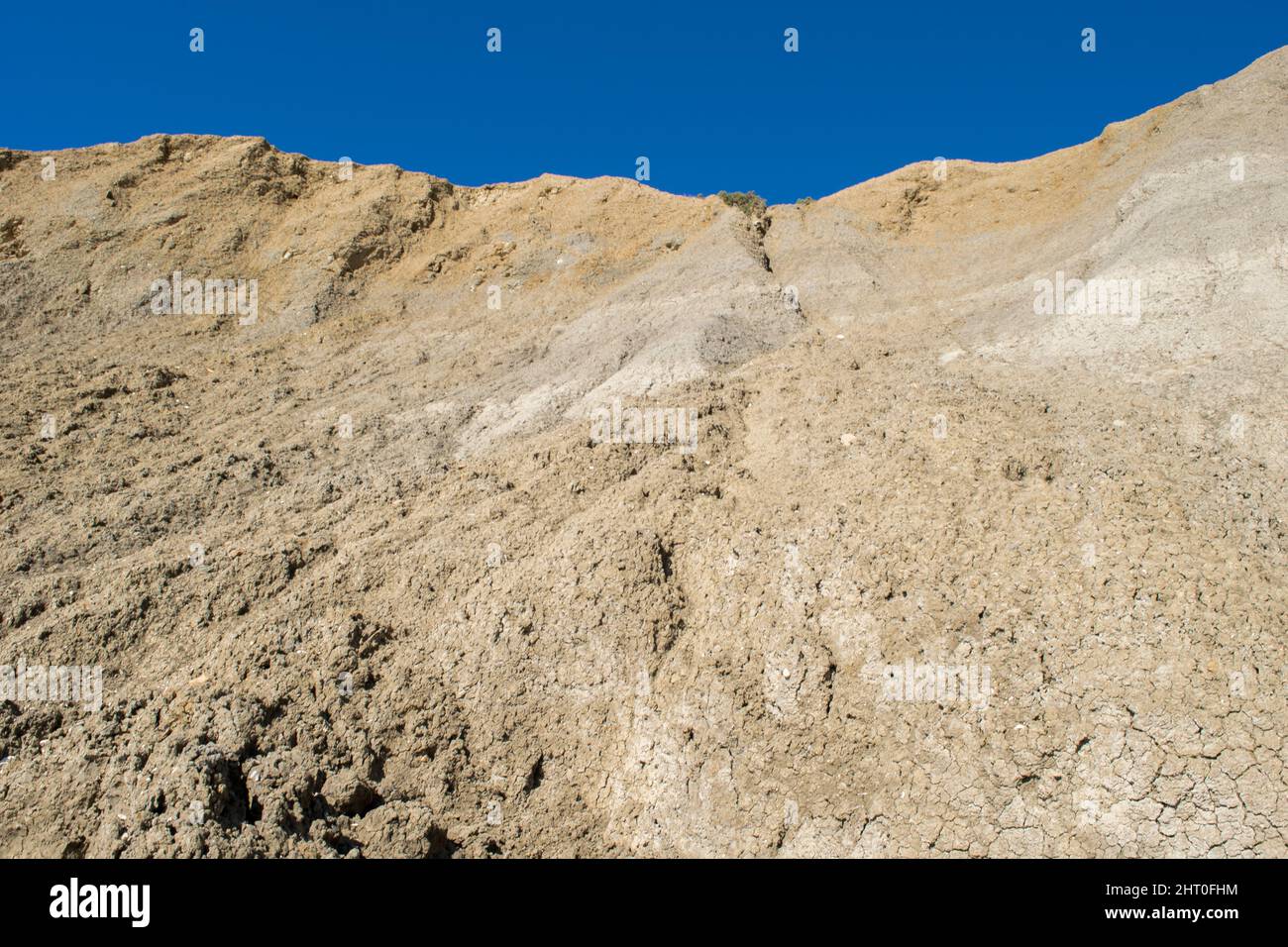 Steep blue clay slopes, with flaking debris forming scree on limestone ...
