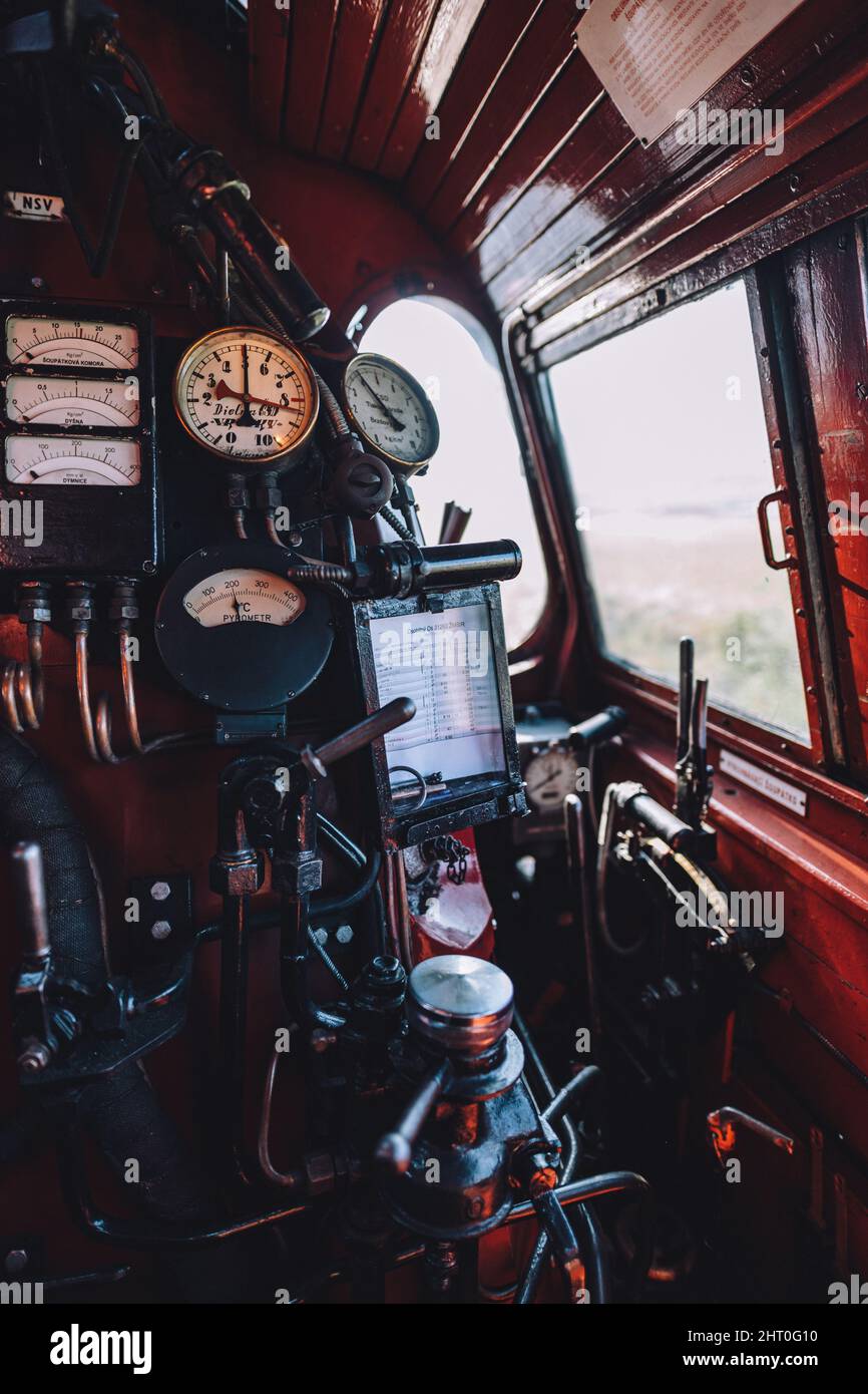 Controls and dials inside the cabin of steam engine locomotive 475.196 ...