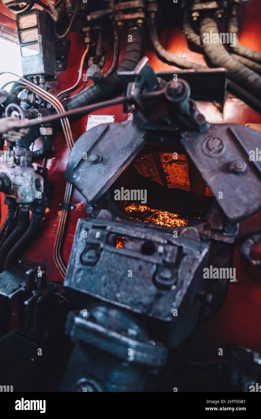 Closeup shot into the furnace inside the cabin of steam engine ...