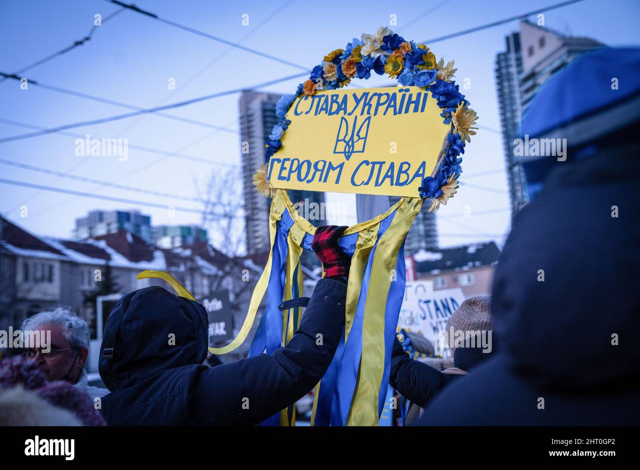 Toronto, Canada. 25th Feb, 2022. A protestor holds a flowered sign ...