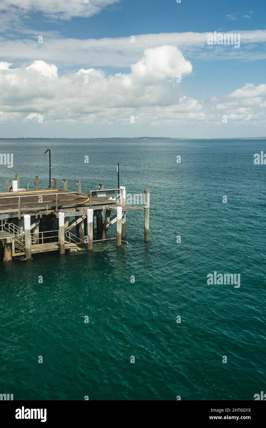 Vertical view of the shore bridge built in the ocean on a sunny day in ...