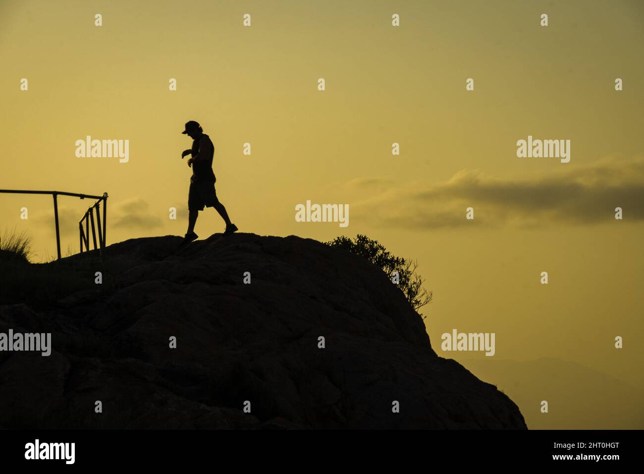Male person silhouette on a hill isolated on a yellow background Stock ...