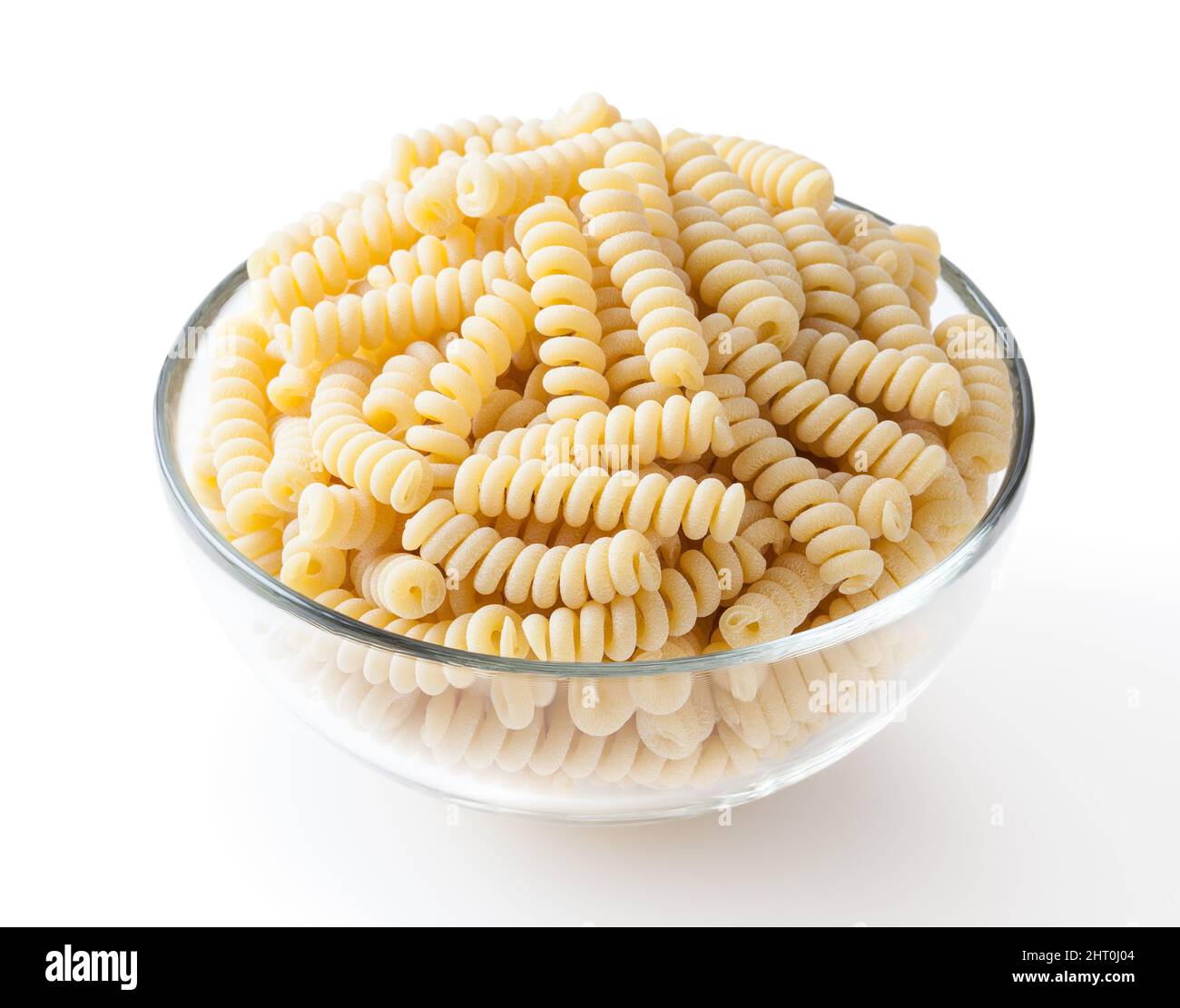 Uncooked fusilli corti bucati pasta in glass bowl isolated on white ...