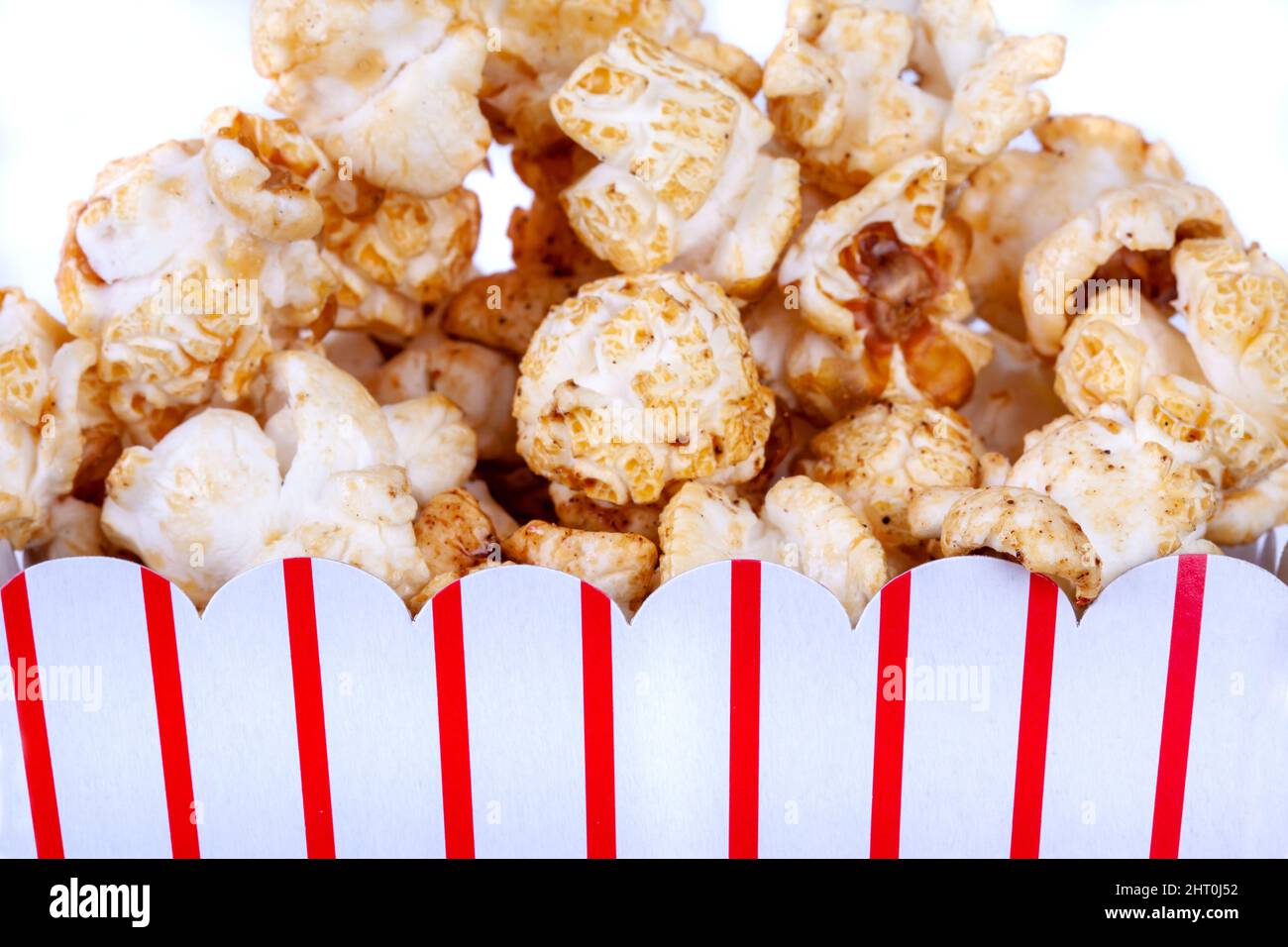 A container of popcorn food close up on a white isolated background ...