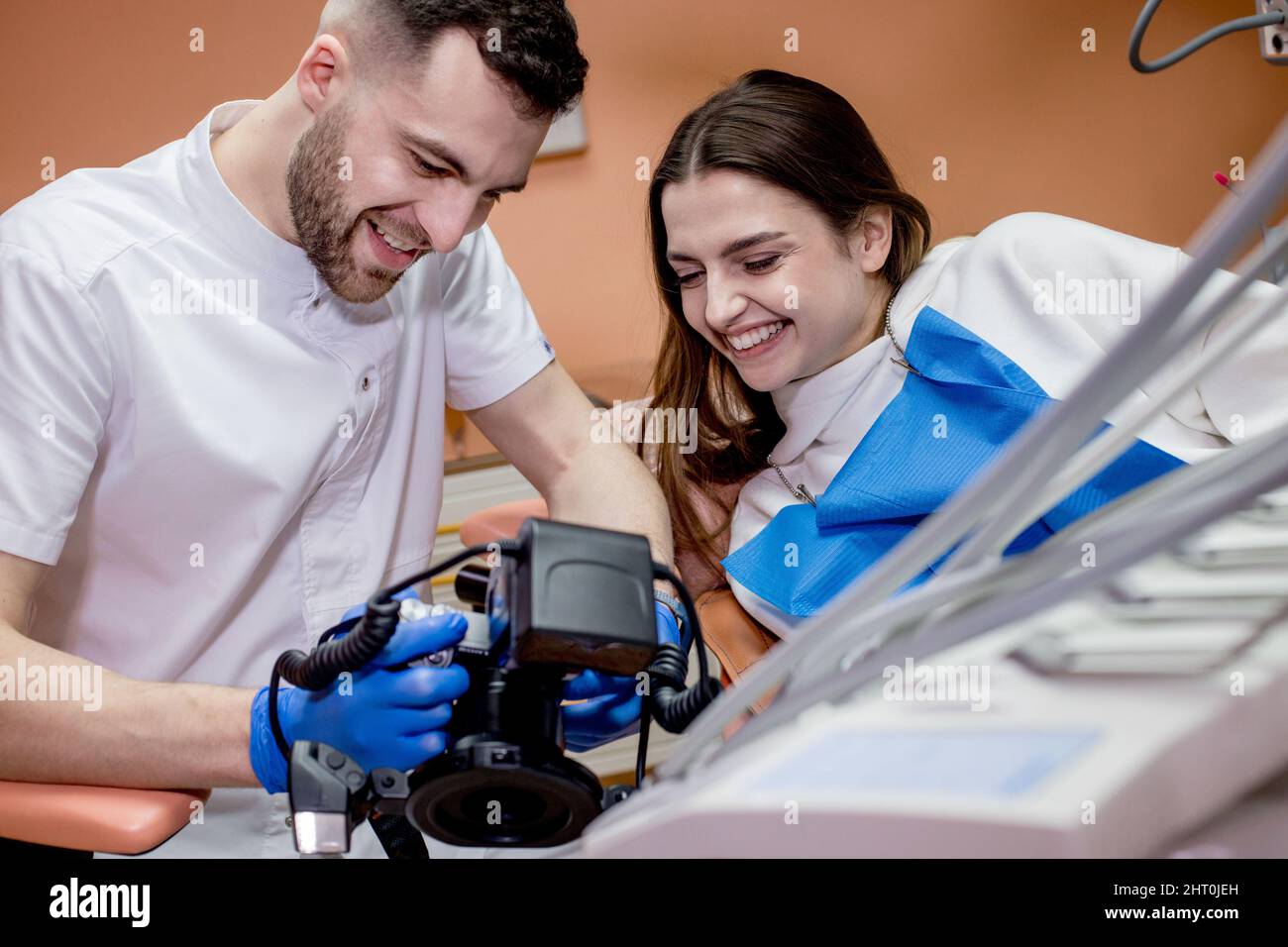 The dentist shows the patient a picture of the result of treatment ...