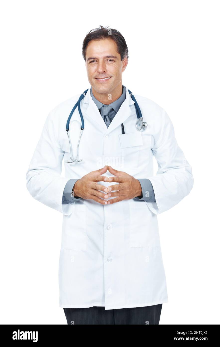 Confident middle aged doctor standing isolated on white. Portrait of a ...