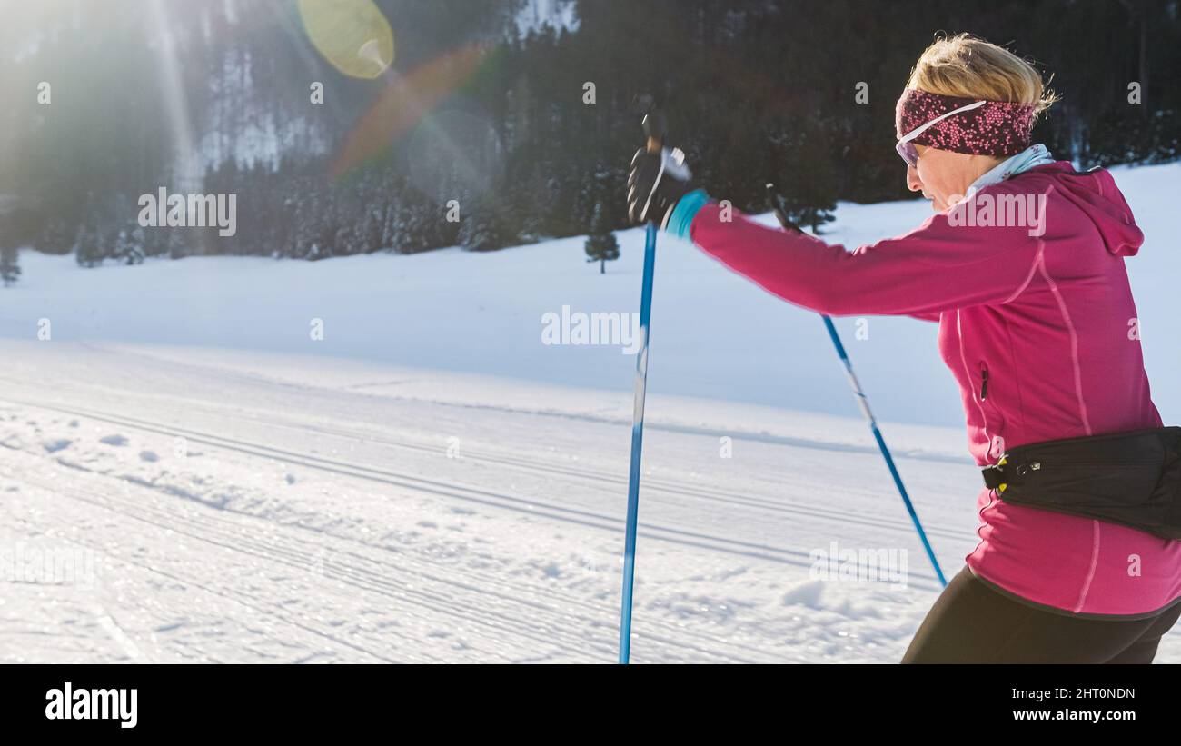 Caucasian middle aged woman, in ski wear and gear cross country style ...