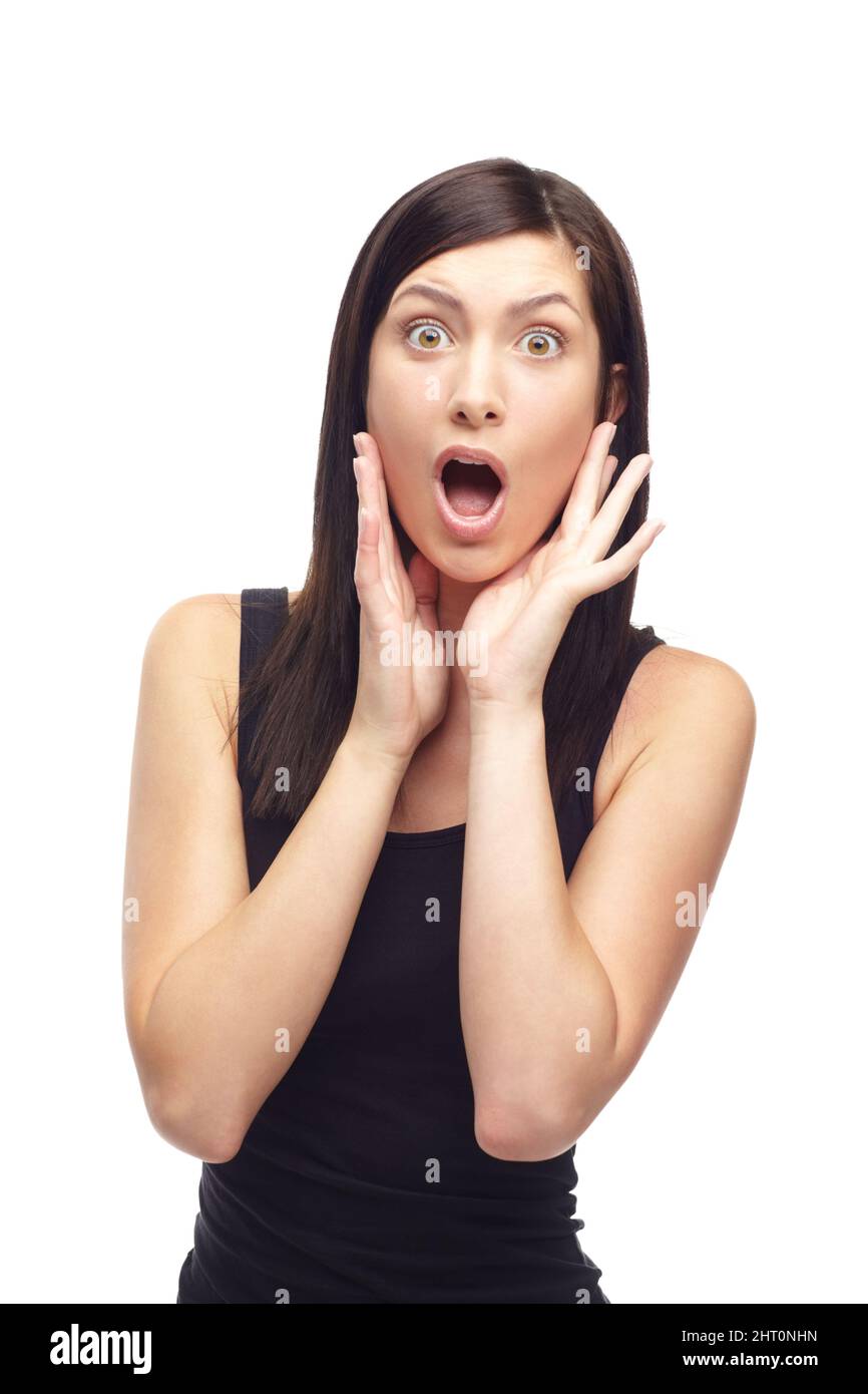 Shock Horror. A shocked young woman isolated on a white background ...