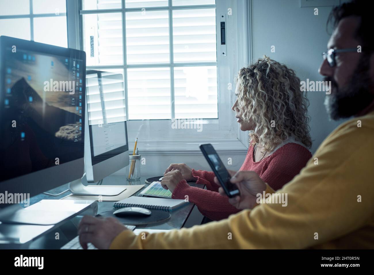 Adult caucasian couple at home in smart working and remote work job ...