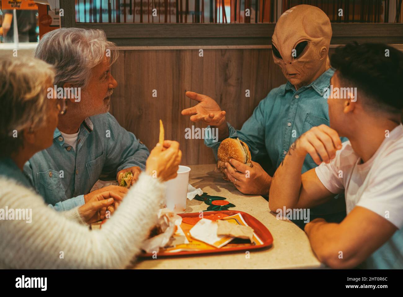 Happy family with ufo alien estraterrestrial guest enjoy together ...