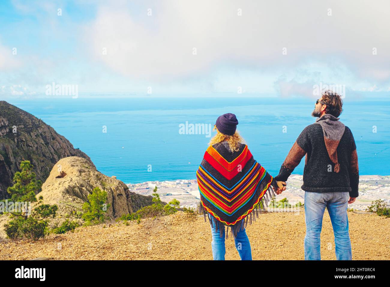 Tourist couple holding hands and admiring nature around. People in love ...