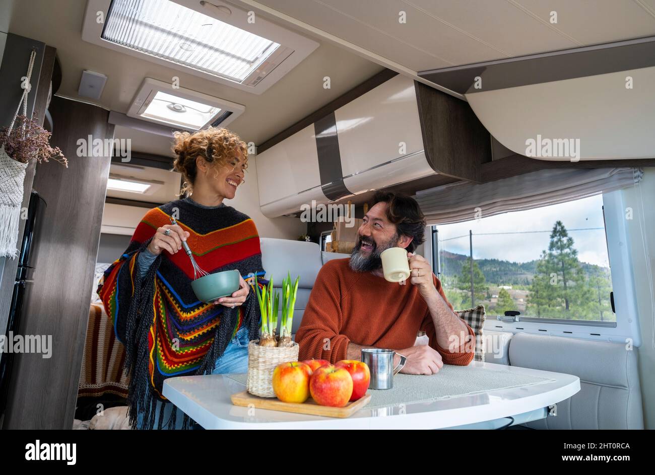 Caucasian couple of vanlifers or tourist enjoy leisure activity cooking ...