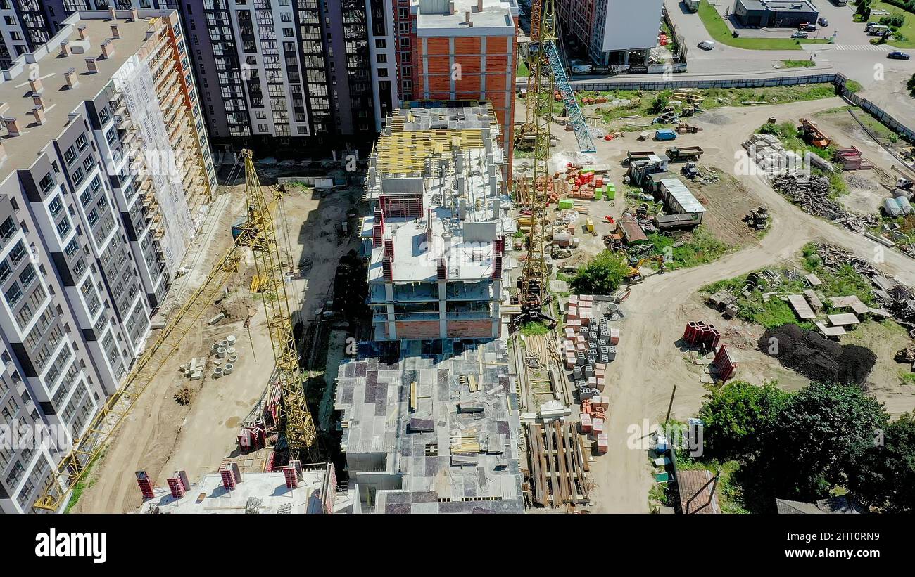Aerial view of high residential apartment building under construction. Real estate development ...