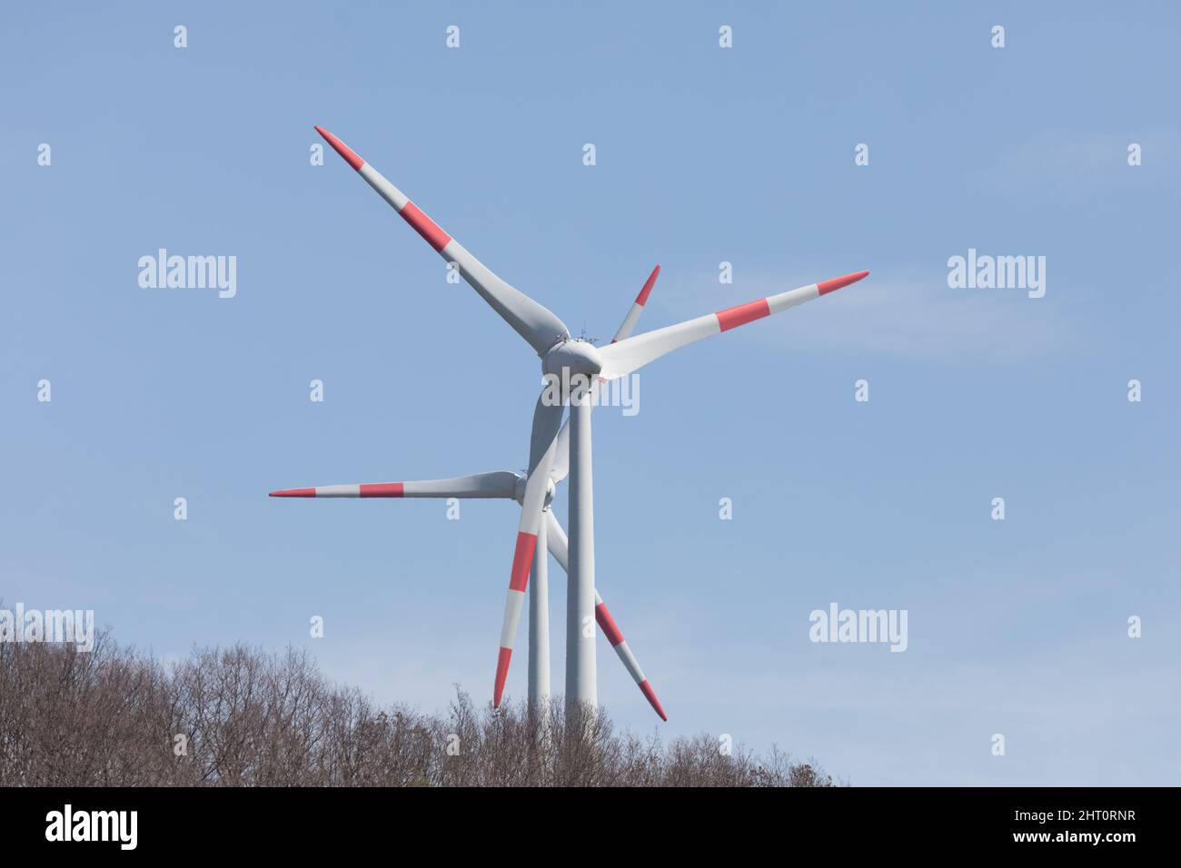 Closeup of striped wind turbines under clear sky Stock Photo - Alamy